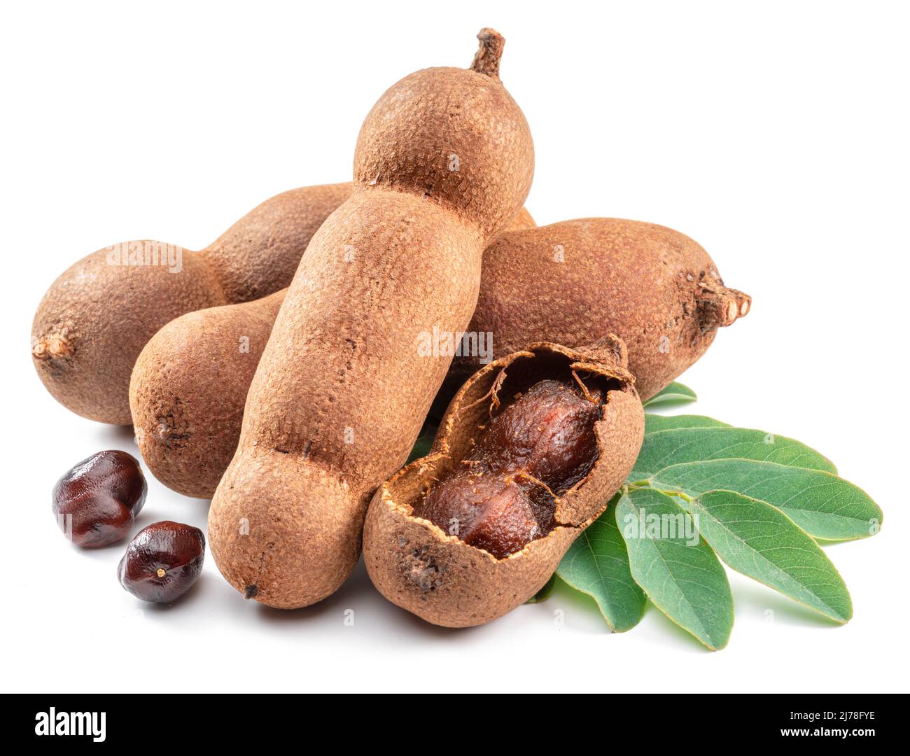 Ripe tamarind fruit, leaves and some tamarind seeds isolated on white ...
