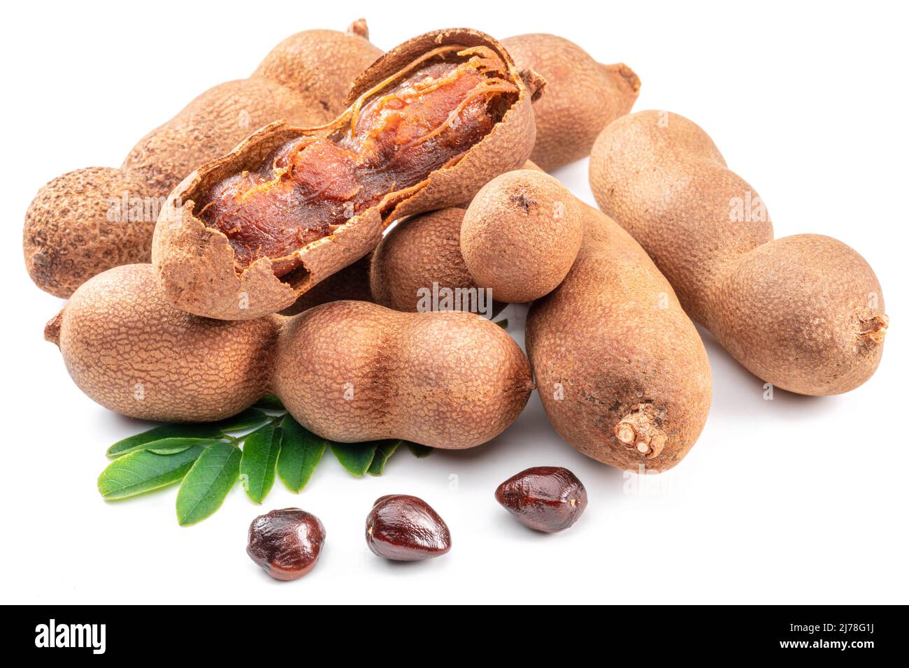 Ripe tamarind fruit, leaves and some tamarind seeds isolated on white ...
