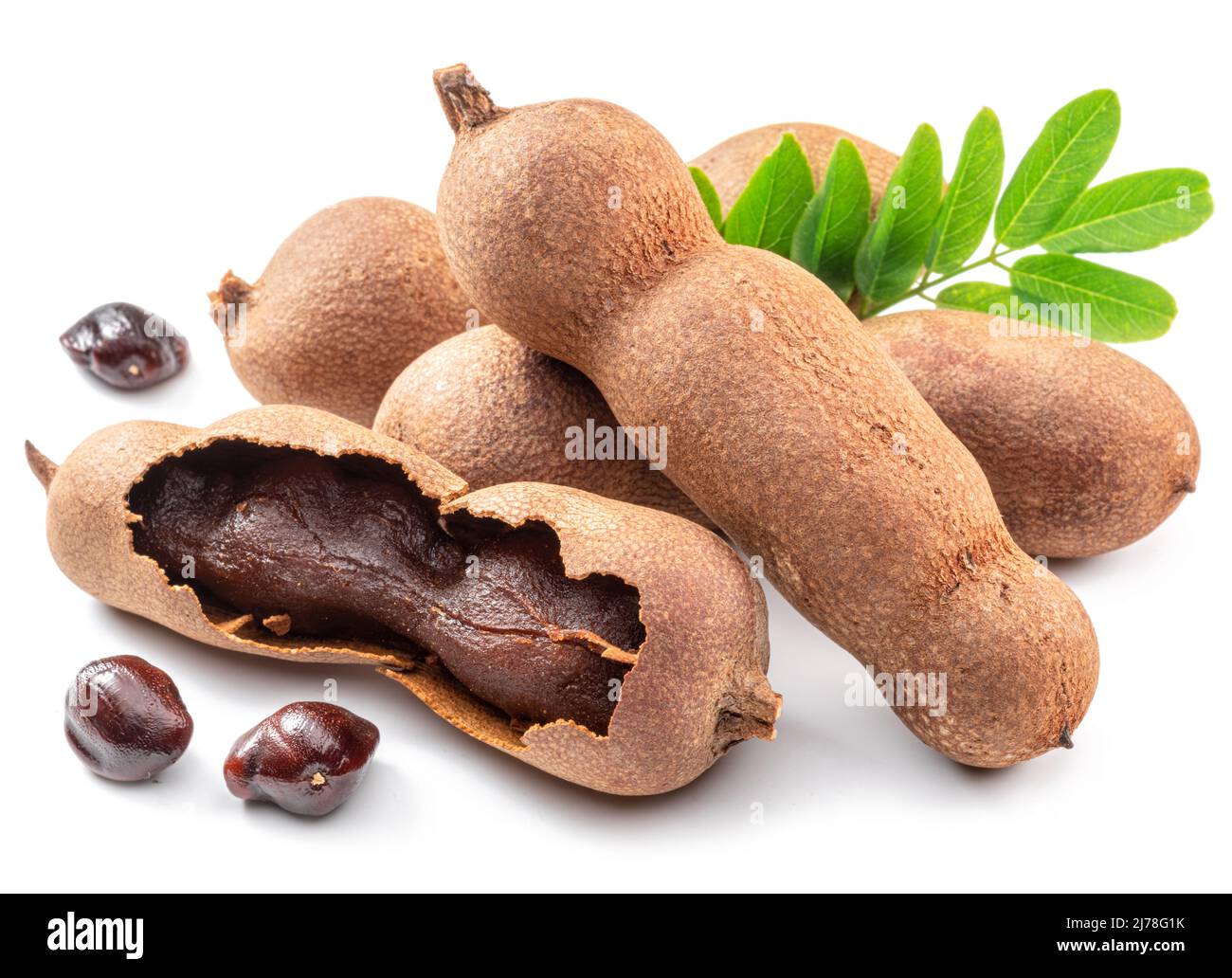 Ripe tamarind fruit, leaves and some tamarind seeds isolated on white ...