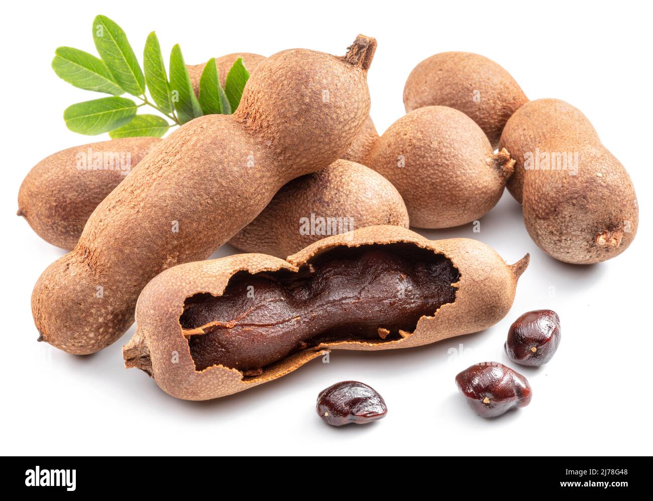 Ripe tamarind fruit, leaves and some tamarind seeds isolated on white ...