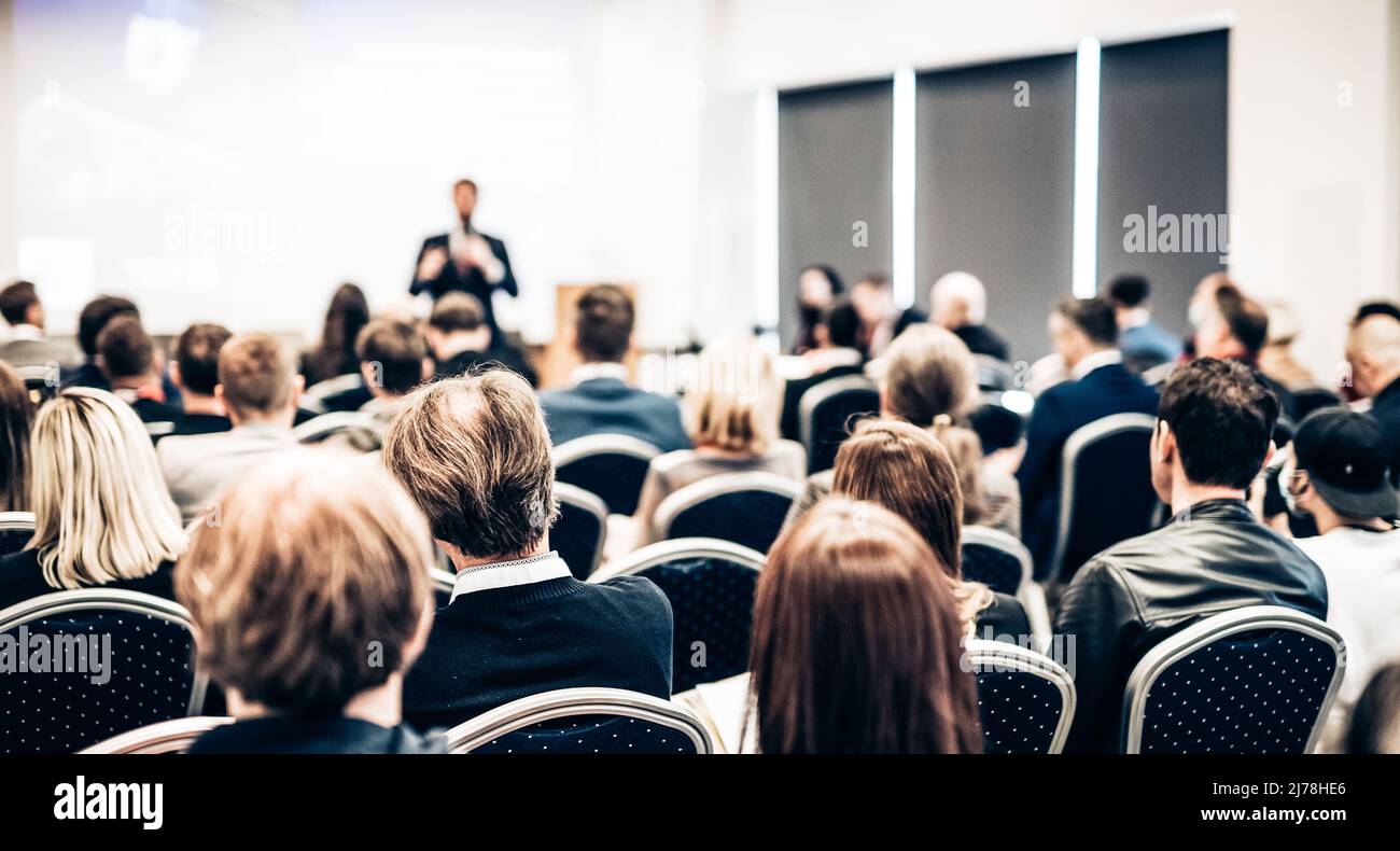 Speaker giving a talk in conference hall at business event. Rear view ...