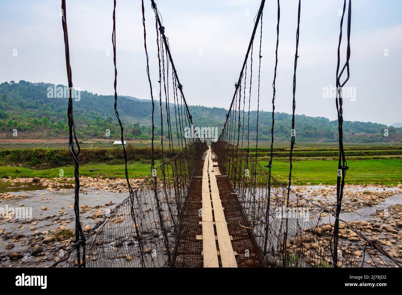 isolated iron suspension bridge old with misty mountain background at ...