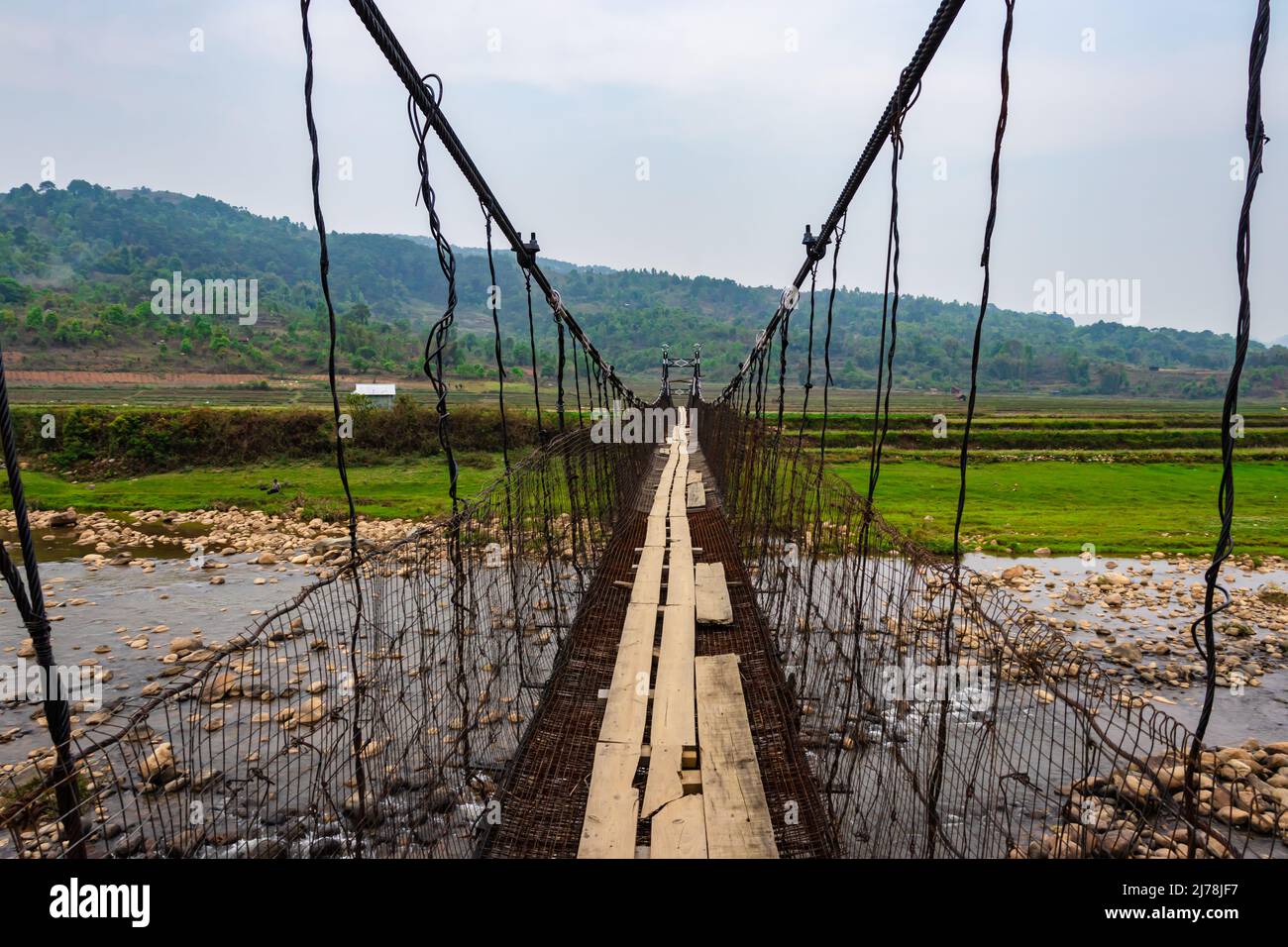 isolated iron suspension bridge old with misty mountain background at ...