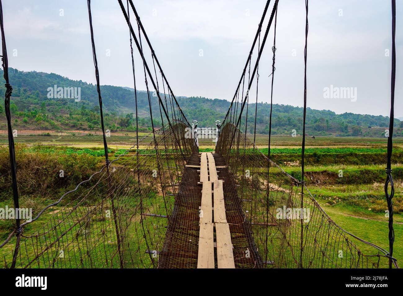 isolated iron suspension bridge old with misty mountain background at ...