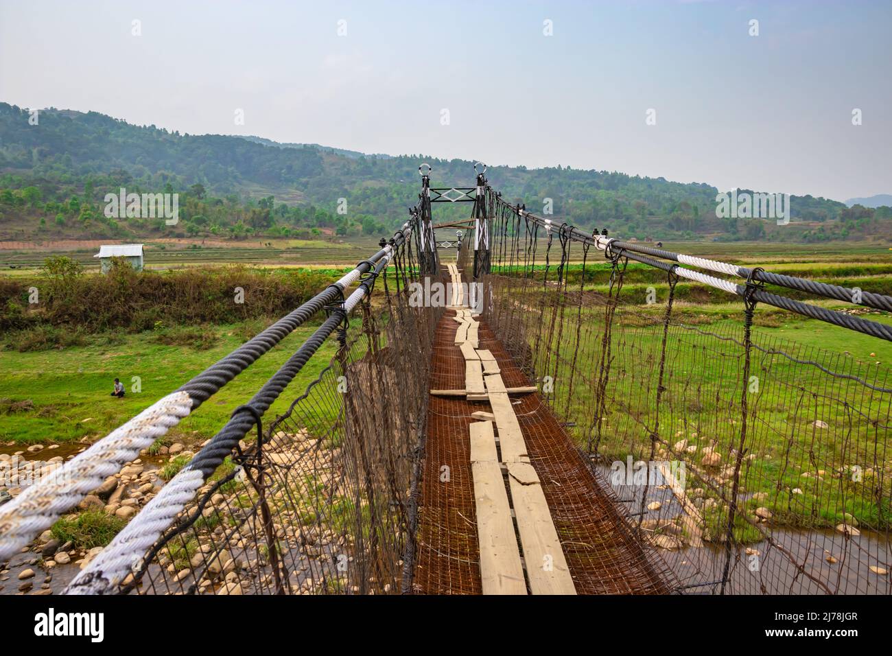 isolated iron suspension bridge old with misty mountain background at ...