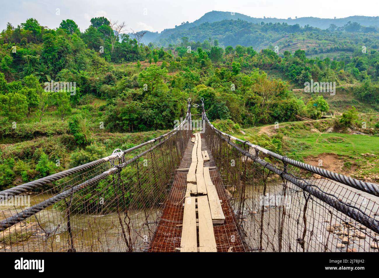 isolated iron suspension bridge old with misty mountain background at ...