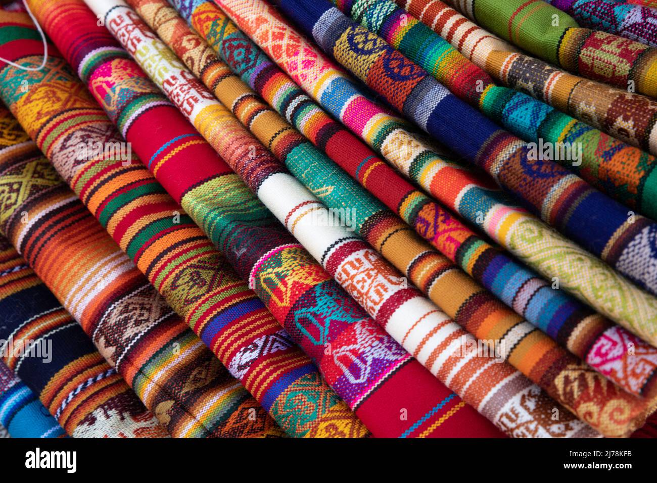 Colorful Andean fabric textiles on the local souvenir market in Otavalo ...