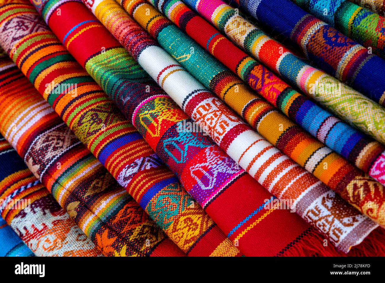 Colorful Andean fabric textiles on the local souvenir market in Otavalo ...