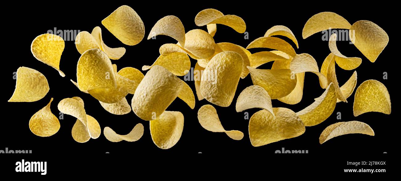 Delicious potato chips floating in the air. Black background. Fast food ...