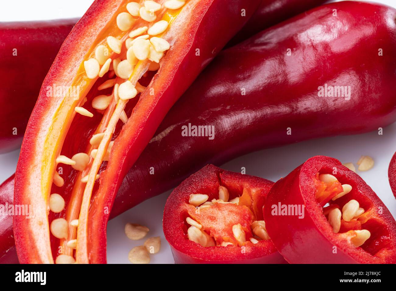 Fresh red chilli peppers and cross section of chilli pepper with seeds ...