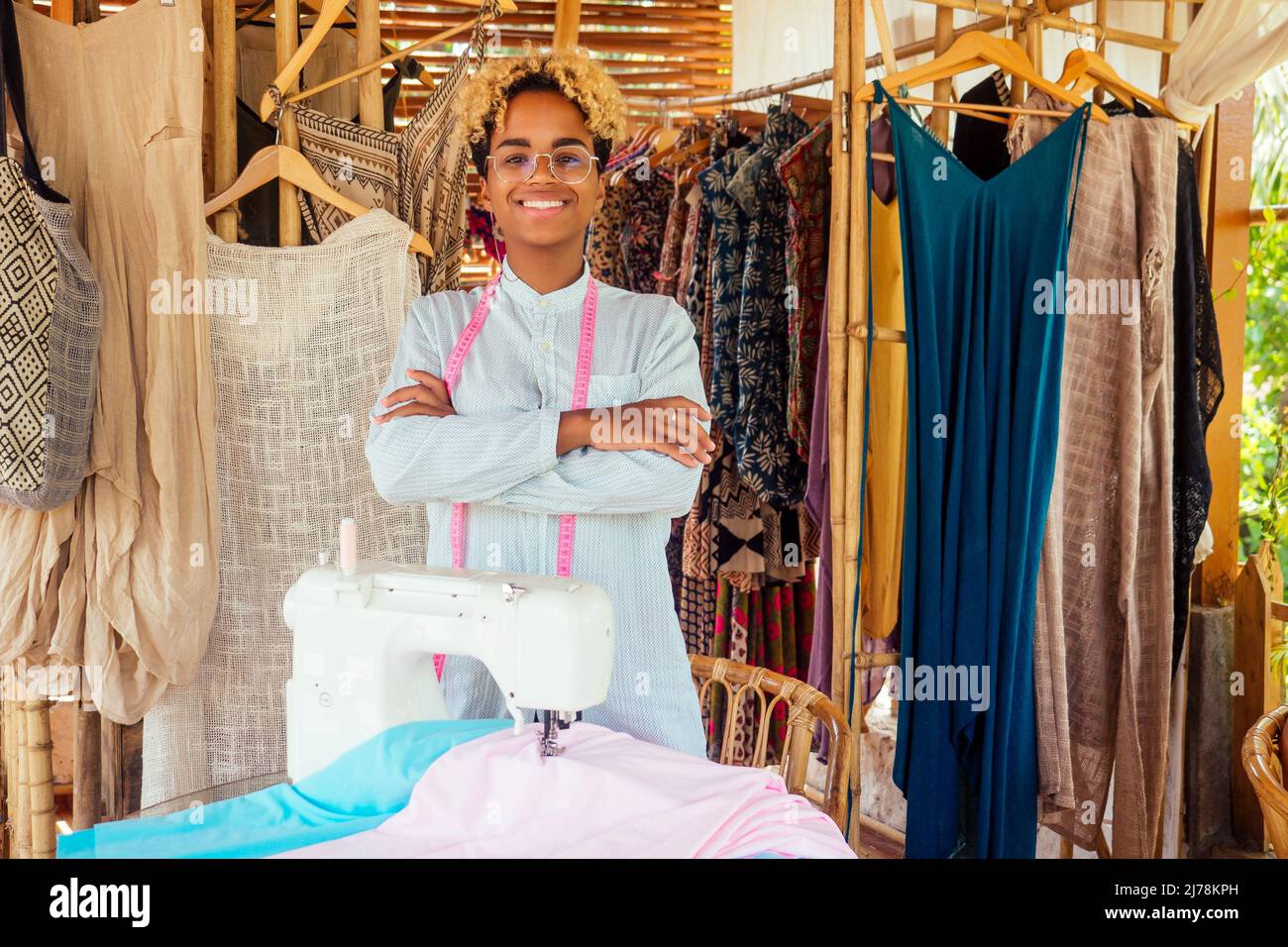 african american woman standing and arms crossed near her sewing ...