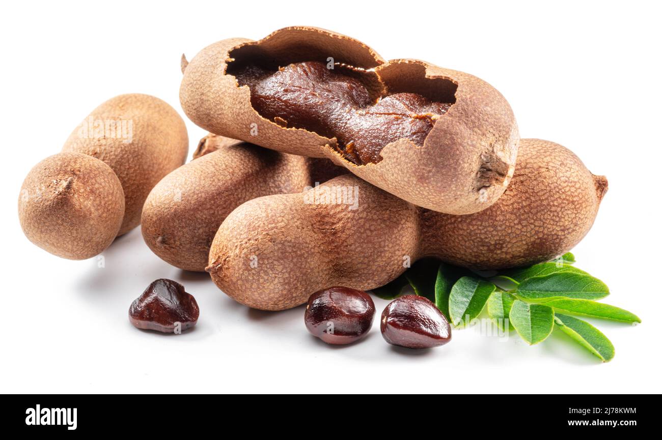 Ripe tamarind fruit, leaves and some tamarind seeds isolated on white ...