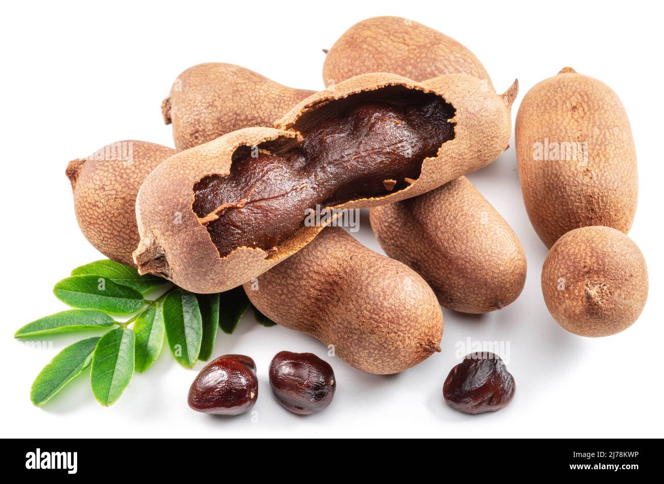 Ripe tamarind fruit, leaves and some tamarind seeds isolated on white ...