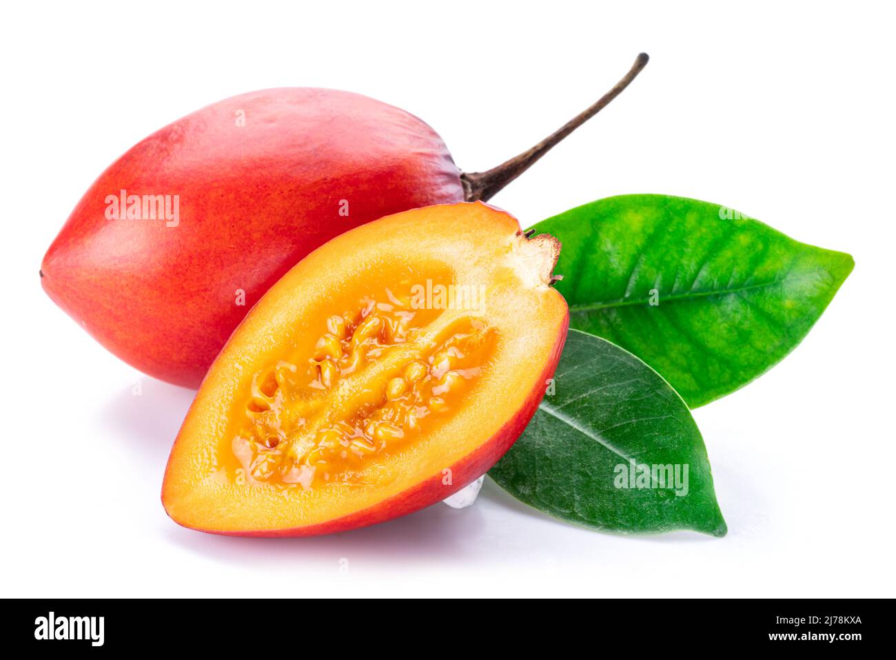 Ripe tamarillo fruits with slices and tamarillo leaves isolated on a ...