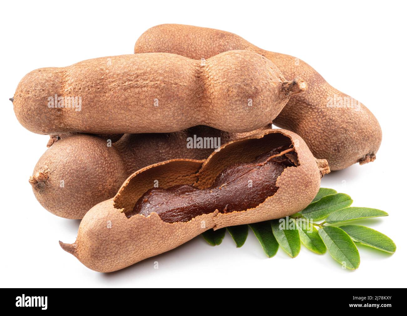 Ripe tamarind fruit, leaves and some tamarind seeds isolated on white ...