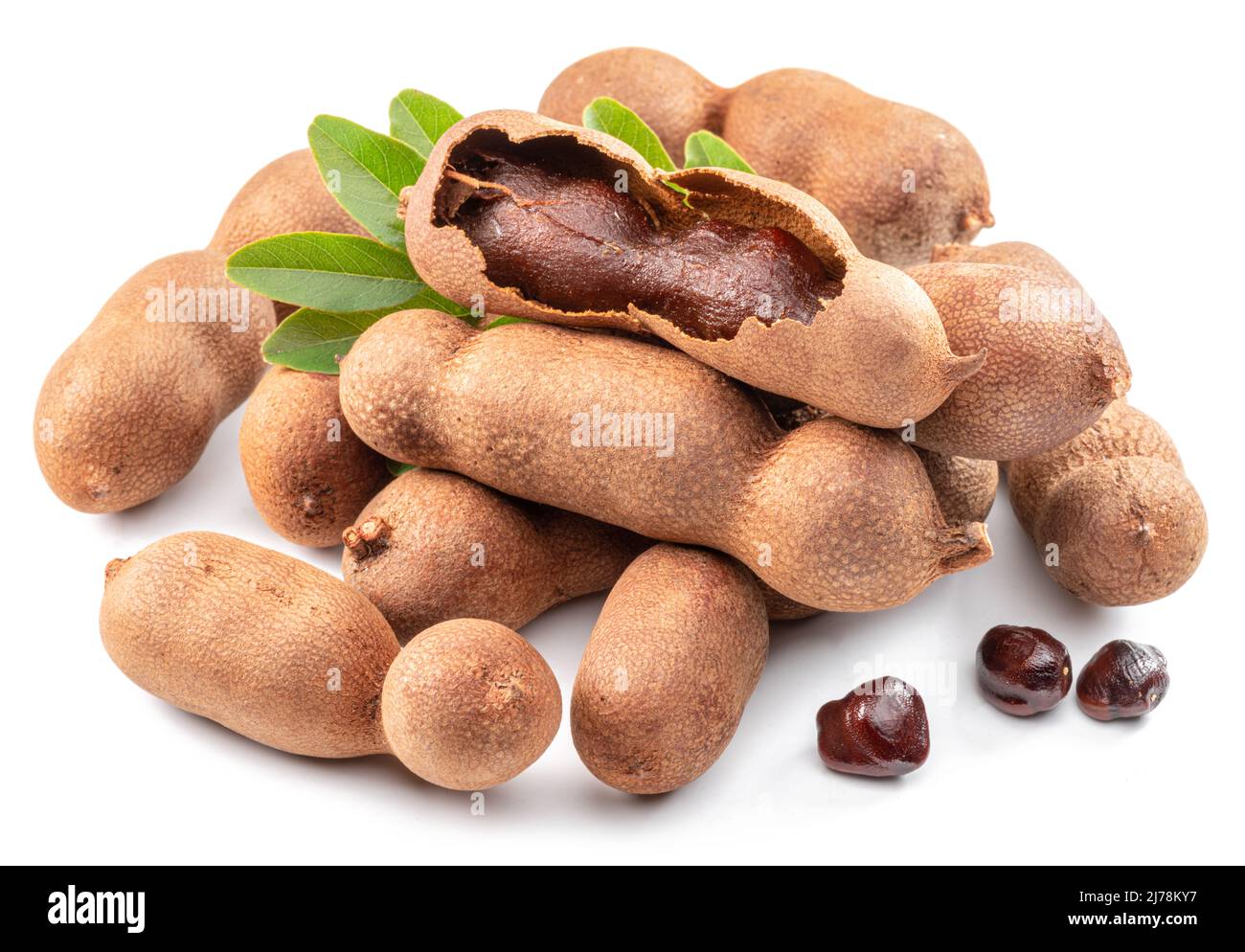 Ripe tamarind fruit, leaves and some tamarind seeds isolated on white ...