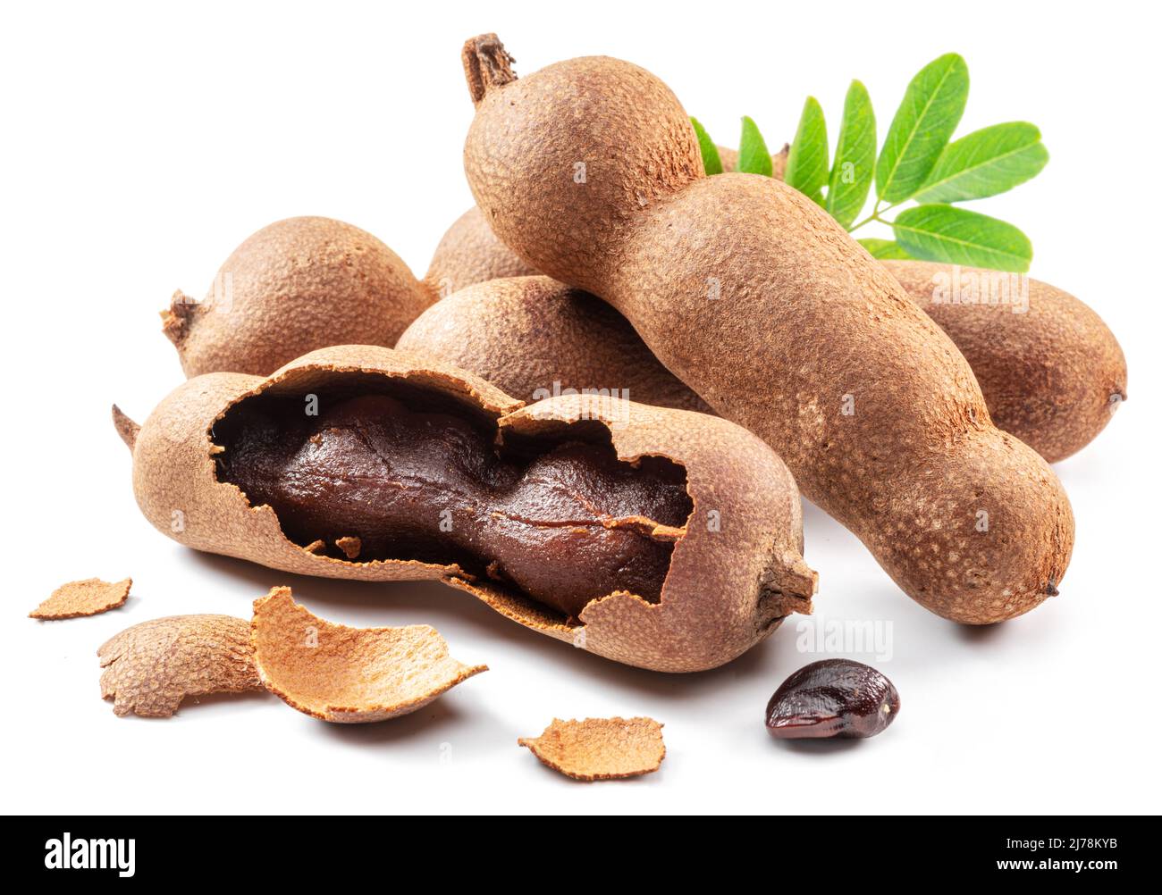 Ripe tamarind fruit, leaves and some tamarind seeds isolated on white ...