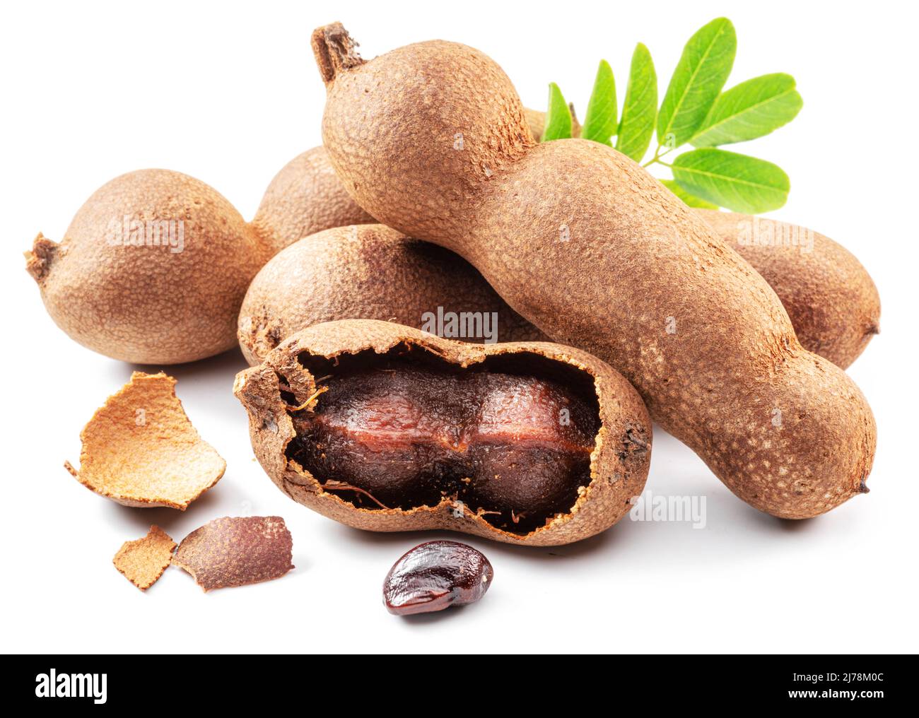 Ripe tamarind fruit, leaves and some tamarind seeds isolated on white ...