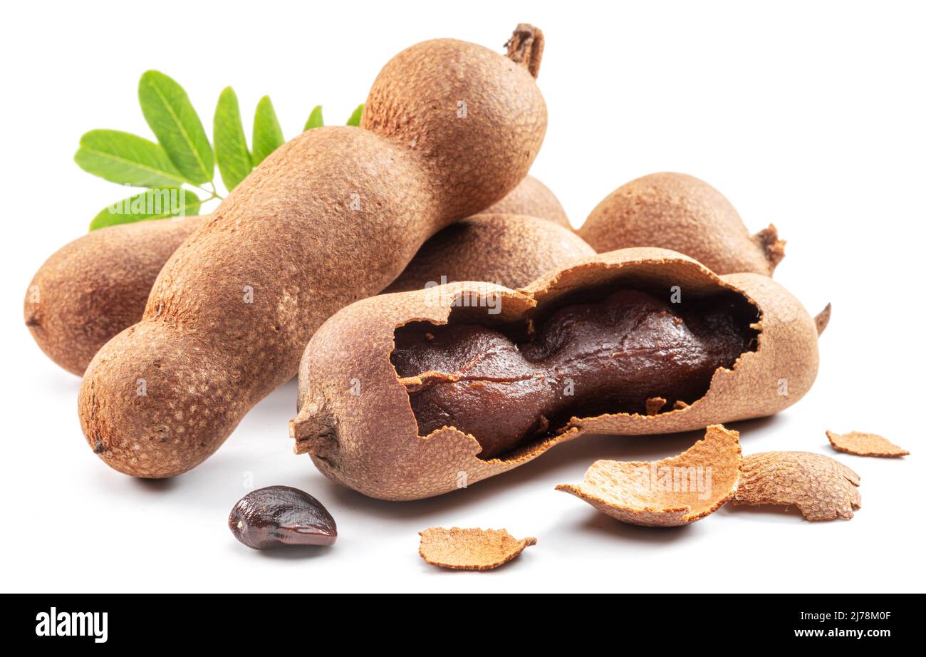 Ripe tamarind fruit, leaves and some tamarind seeds isolated on white ...