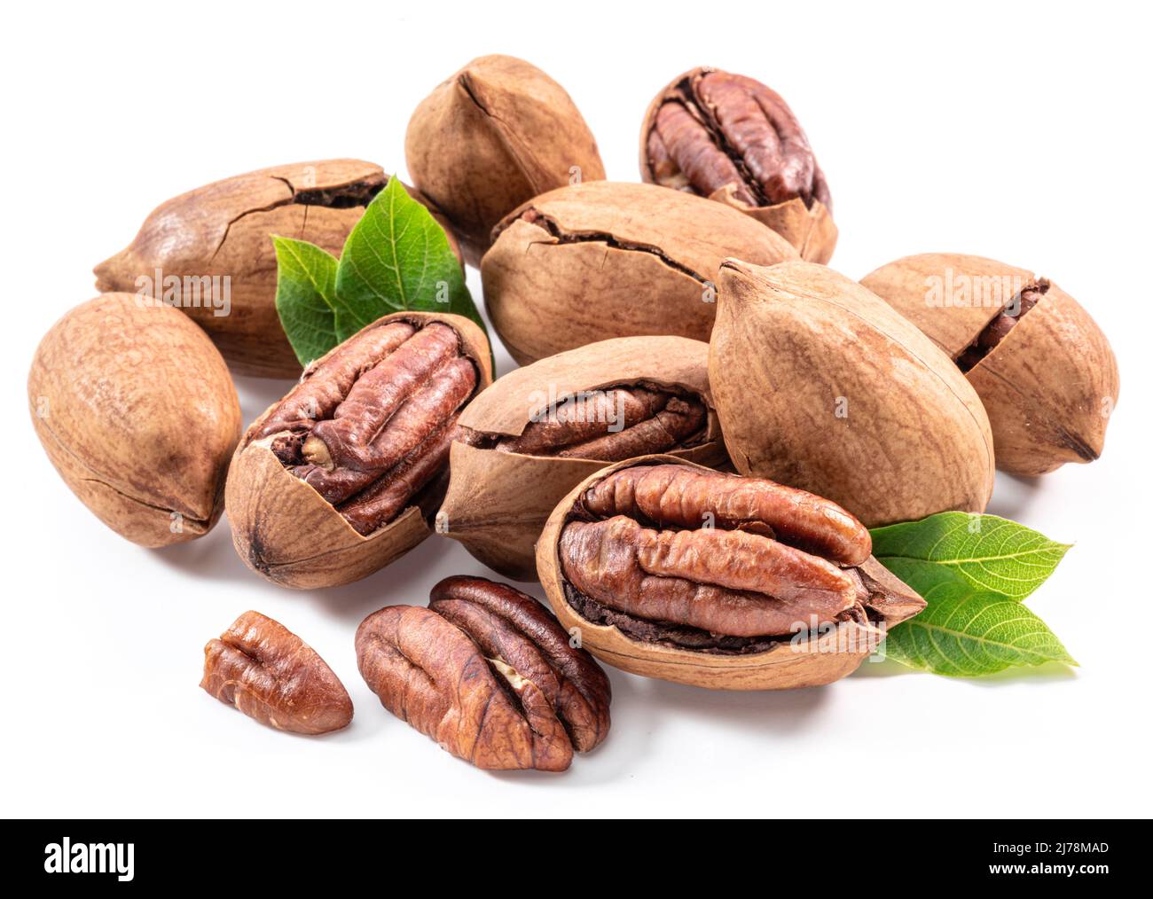 Shelled and cracked pecan nuts with leaves close-up on white background ...