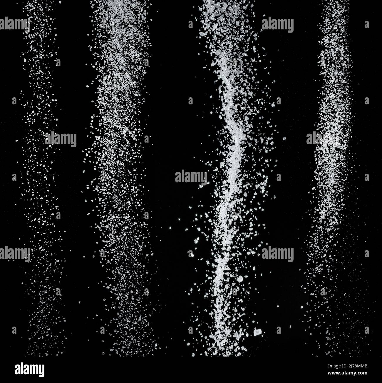 White refined sugar crystals falling down at black background Stock ...