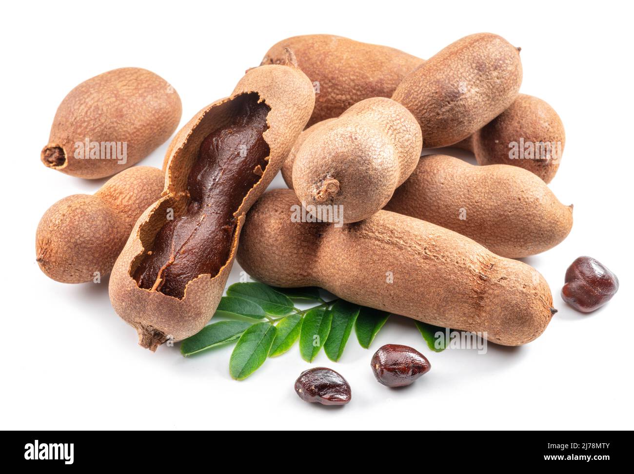 Ripe tamarind fruit, leaves and some tamarind seeds isolated on white ...