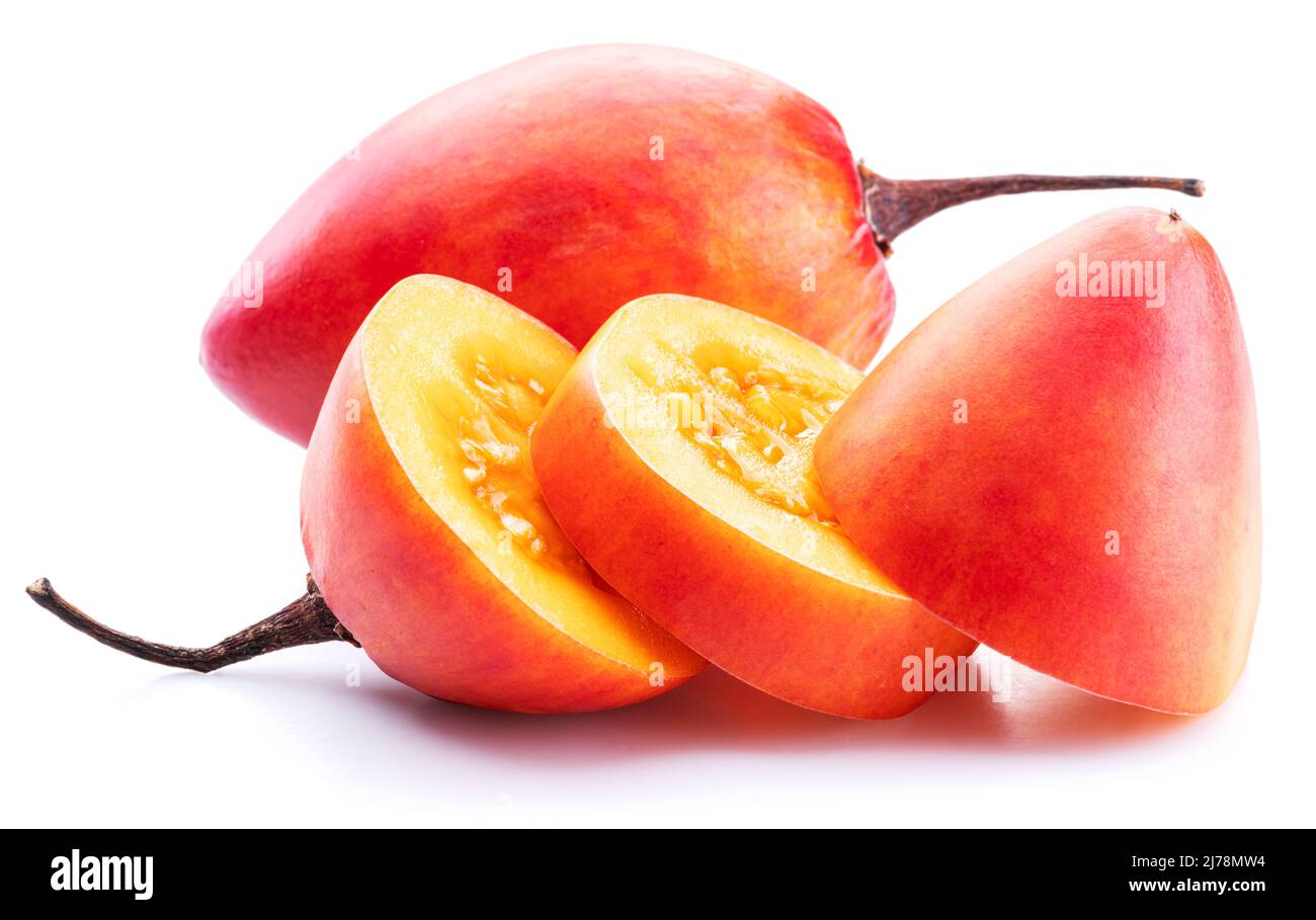Ripe tamarillo fruits with tamarillo slices isolated on a white ...