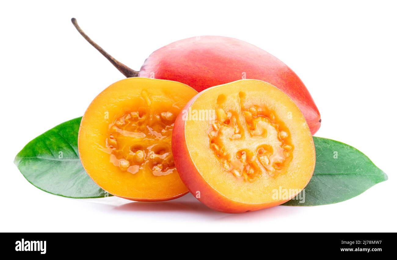 Ripe tamarillo fruits with slices and tamarillo leaves isolated on a ...
