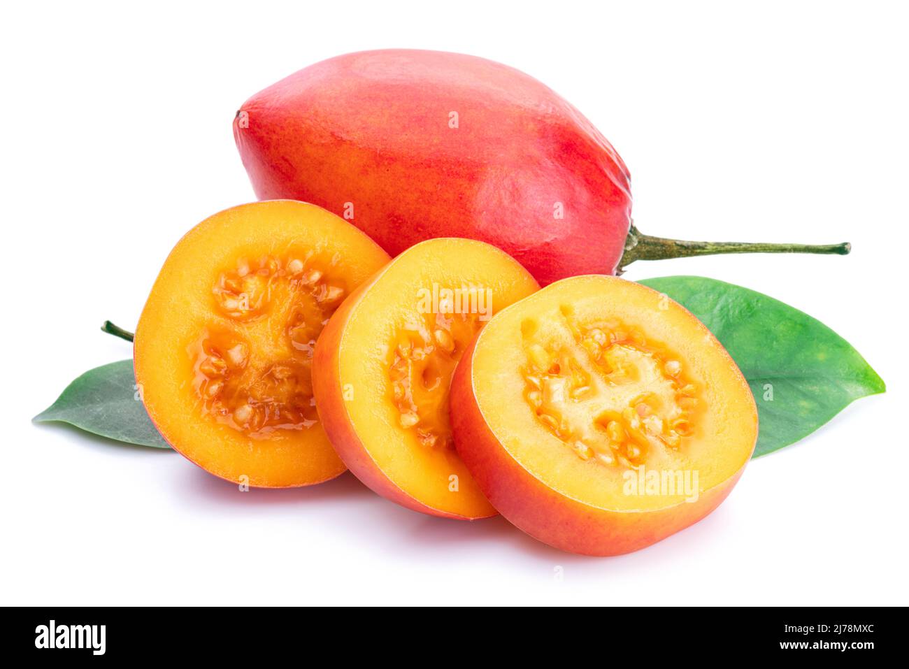 Ripe tamarillo fruits with slices and tamarillo leaves isolated on a ...