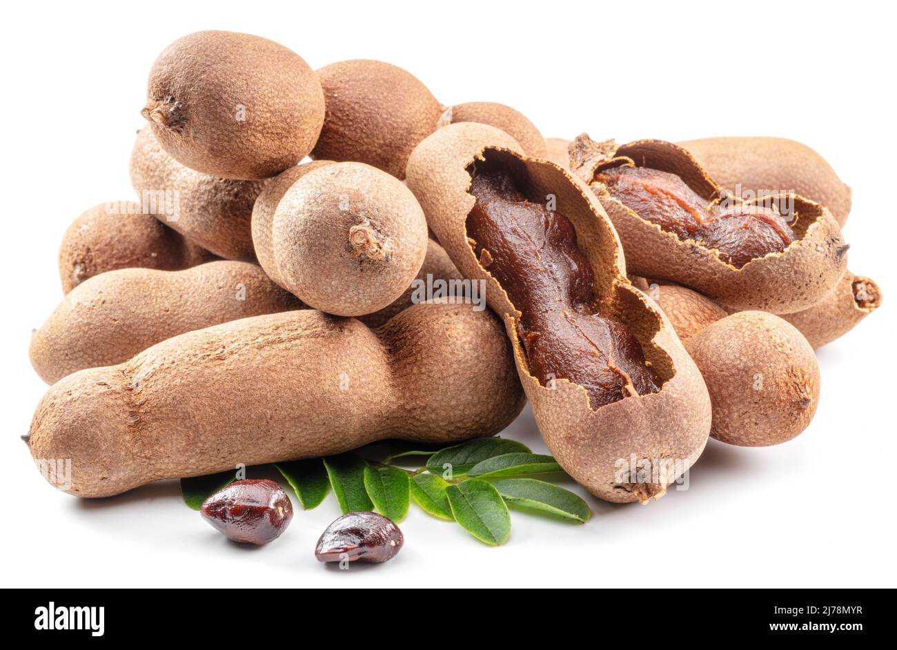Ripe tamarind fruit, leaves and some tamarind seeds isolated on white ...