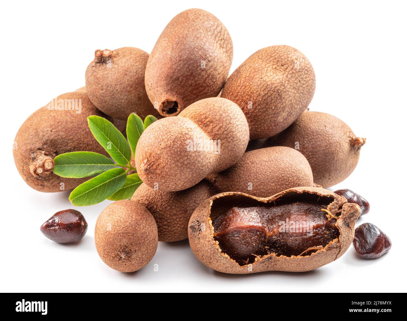 Ripe tamarind fruit, leaves and some tamarind seeds isolated on white ...