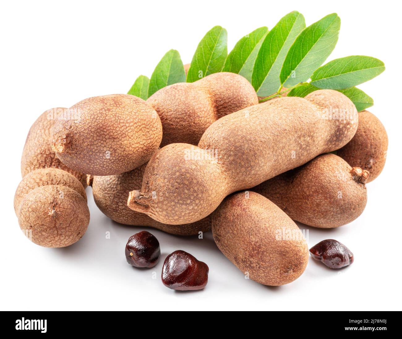 Ripe tamarind fruit, leaves and some tamarind seeds isolated on white ...