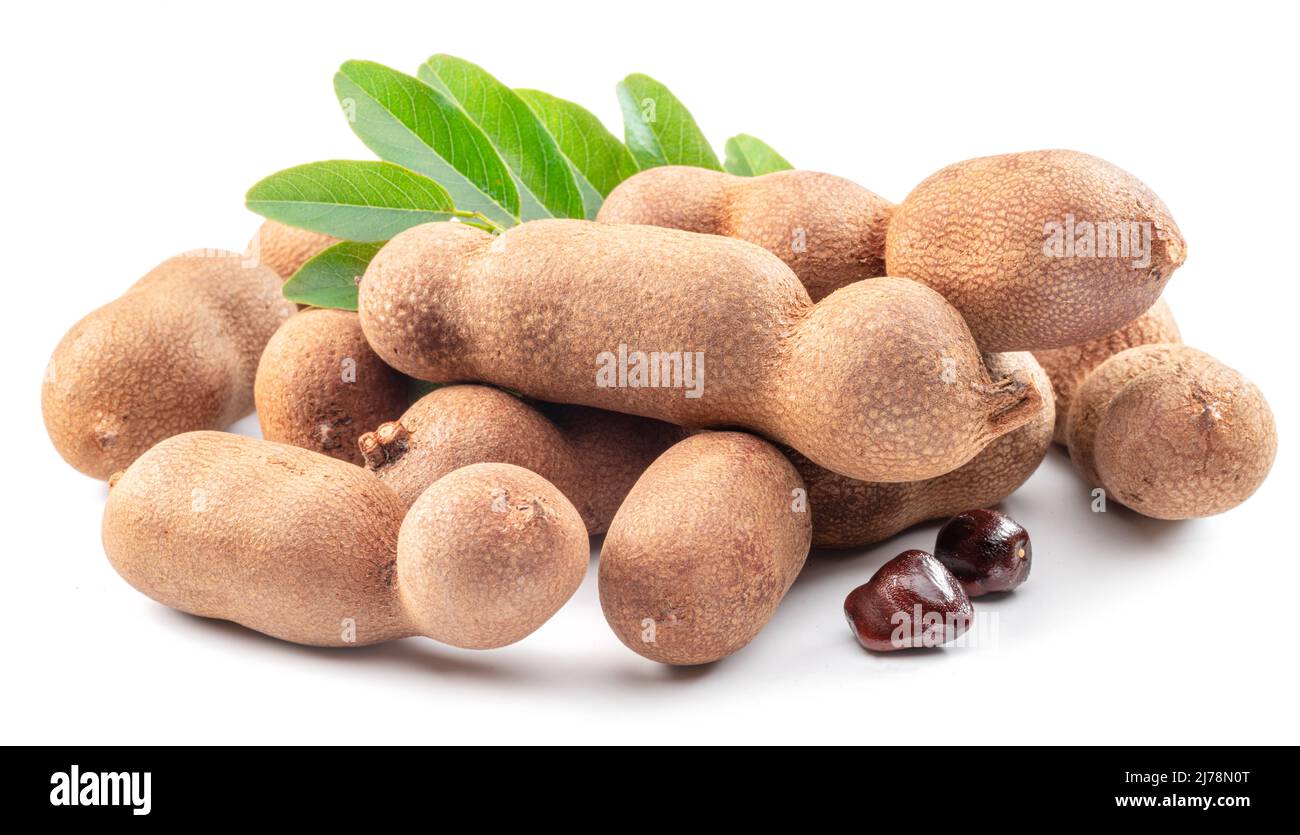 Ripe tamarind fruit, leaves and some tamarind seeds isolated on white ...