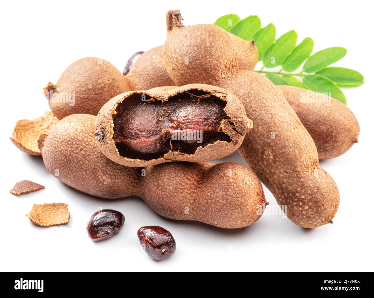 Ripe tamarind fruit, leaves and some tamarind seeds isolated on white ...