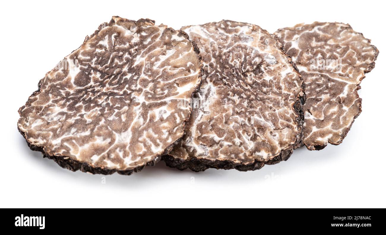 Black winter truffle slices on white background. The most famous of the ...