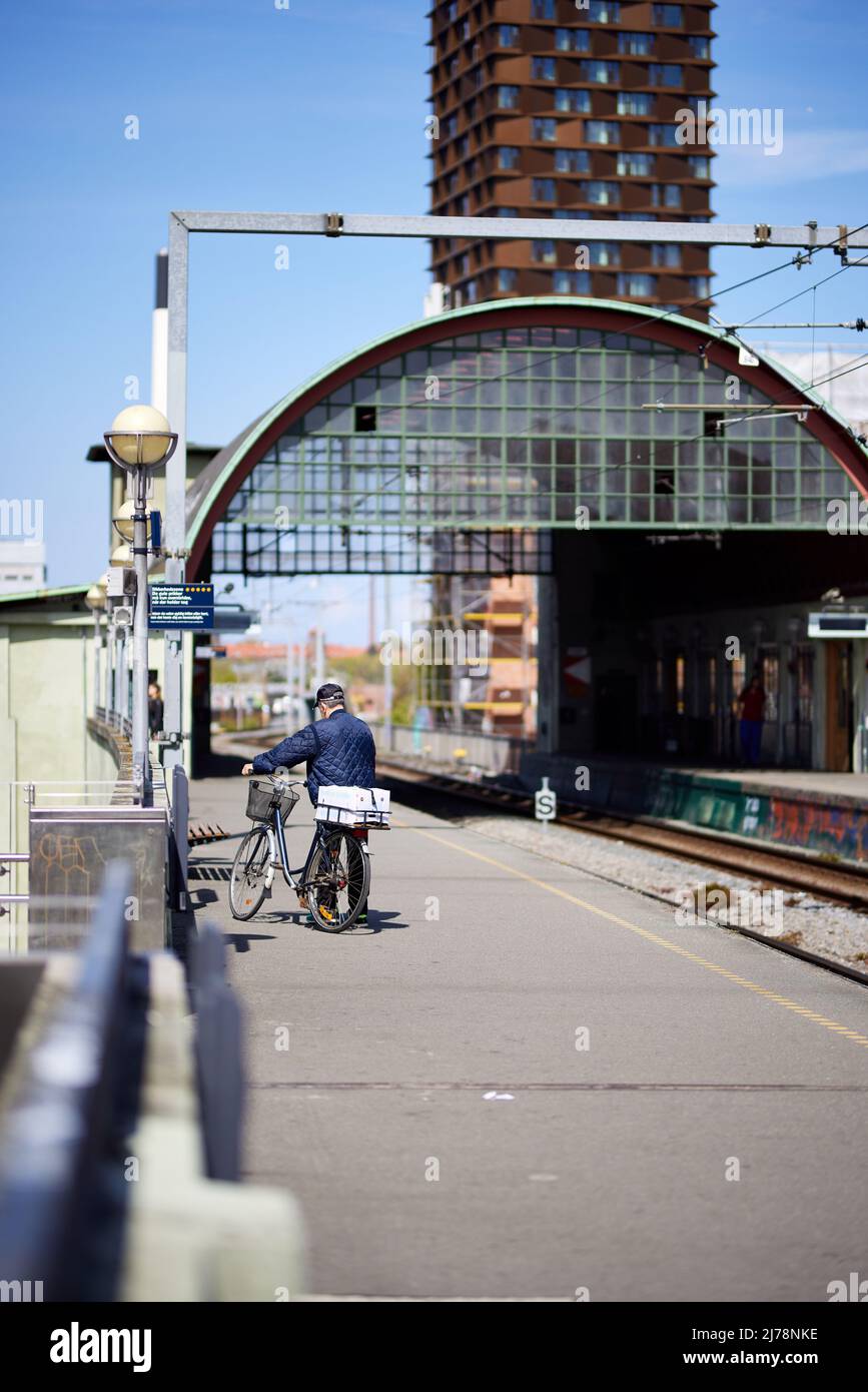 Man with bike on train platform at Nørrebro Station (designed by Knud ...