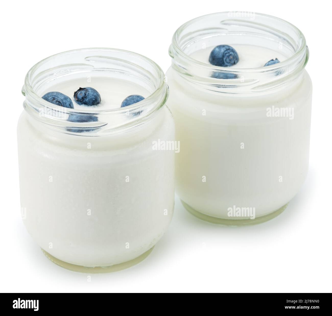 Two glass containers with plain yoghurt and berries isolated on white ...