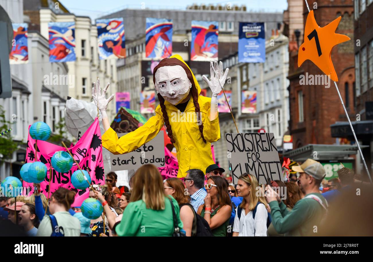 Brighton UK 7th May 2022 - A giant puppet of Greta Thunberg is carried ...