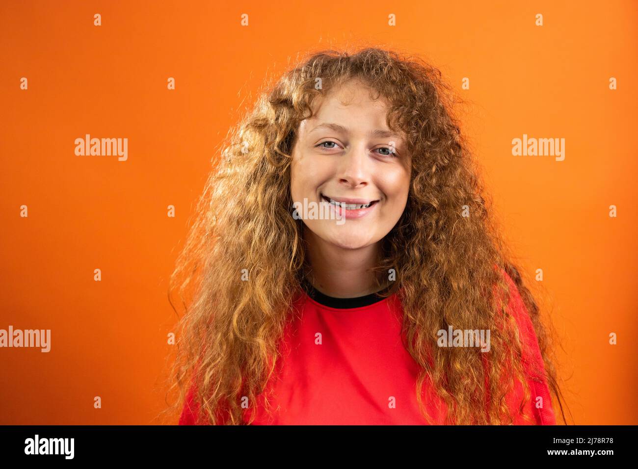 Pretty football fan in red on white background Stock Photo - Alamy