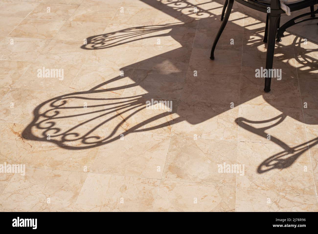 Shadows from empty chairs in a cafe under the hot sun Stock Photo - Alamy