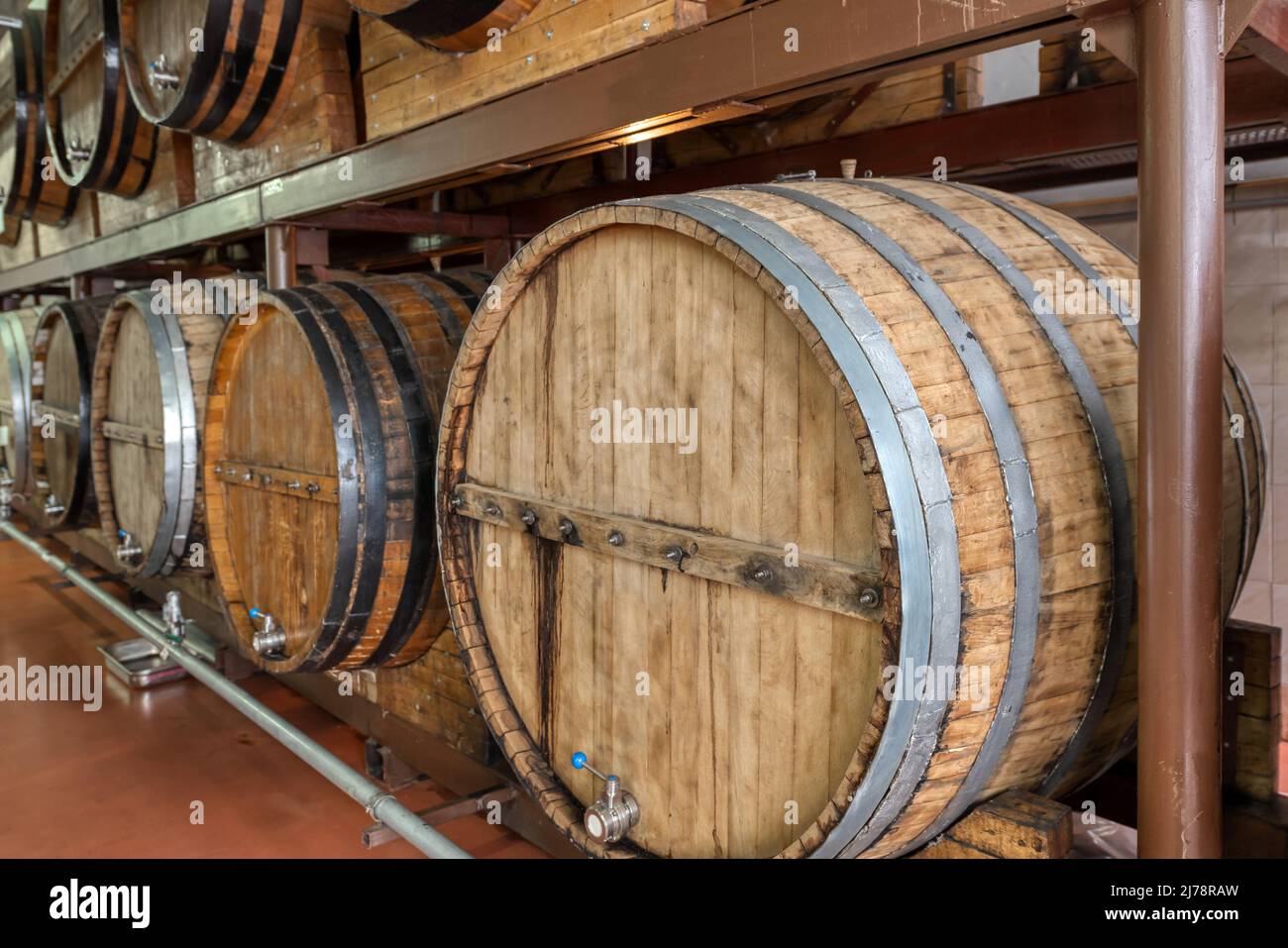 Wooden cask to make luxury alcohol drinks stand in cellar Stock Photo ...
