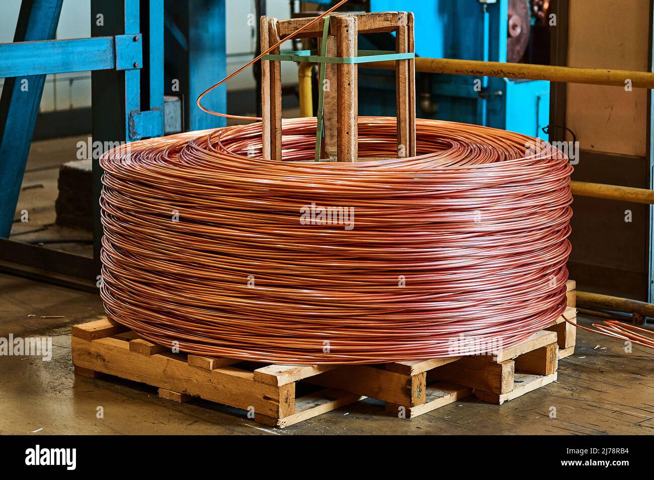 Large bobbin of orange copper wire in light warehouse Stock Photo - Alamy