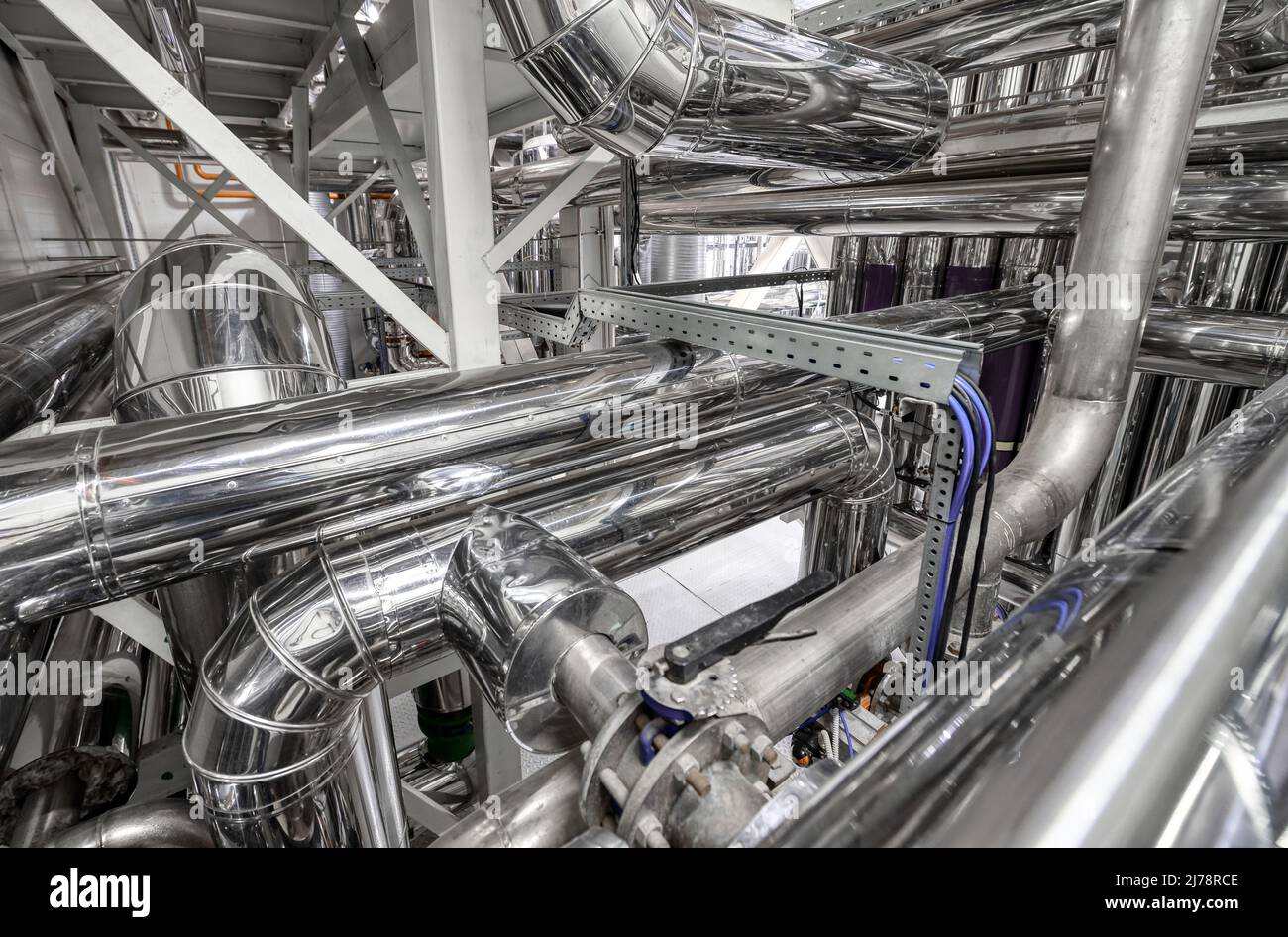 Shiny silver pipeline system and pressure meter at plant Stock Photo ...