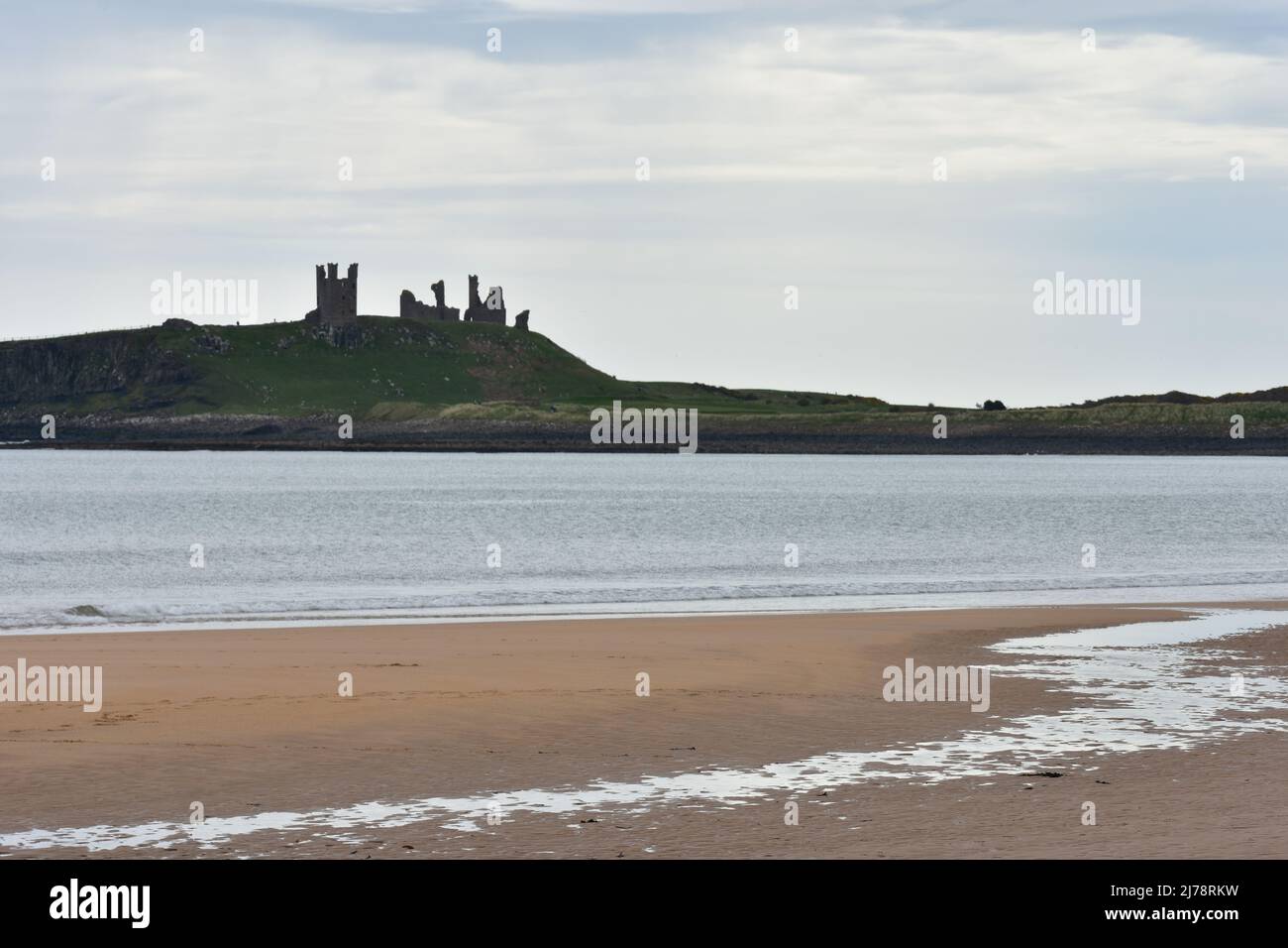 Atmospheric view of Dunstanburgh castle from Embleton bay ...