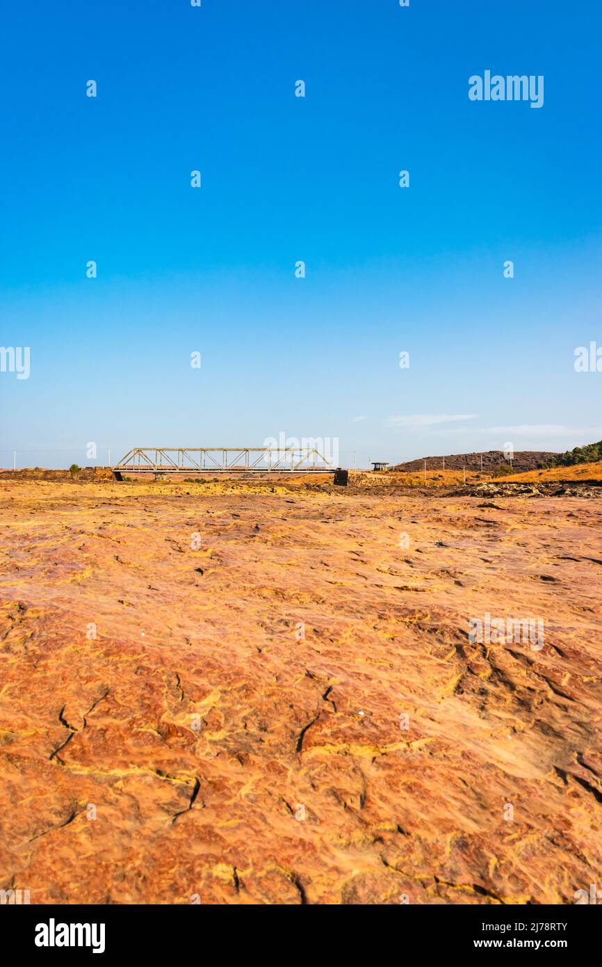 dry river rock formation with vintage iron bridge and blue sky at ...