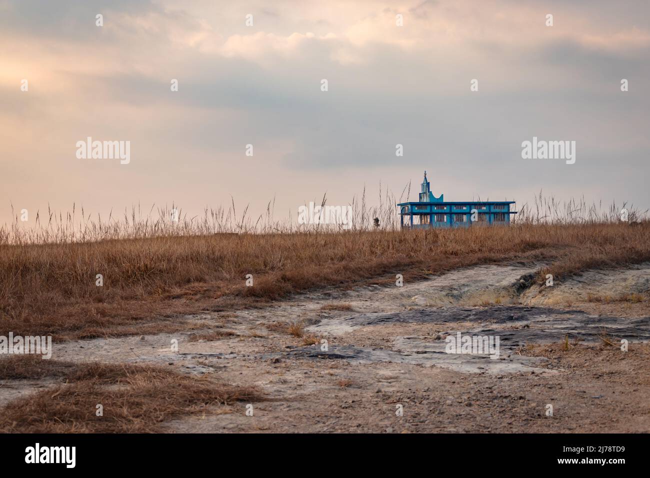 isolated church at yellow grass field with dramatic sky at morning from ...