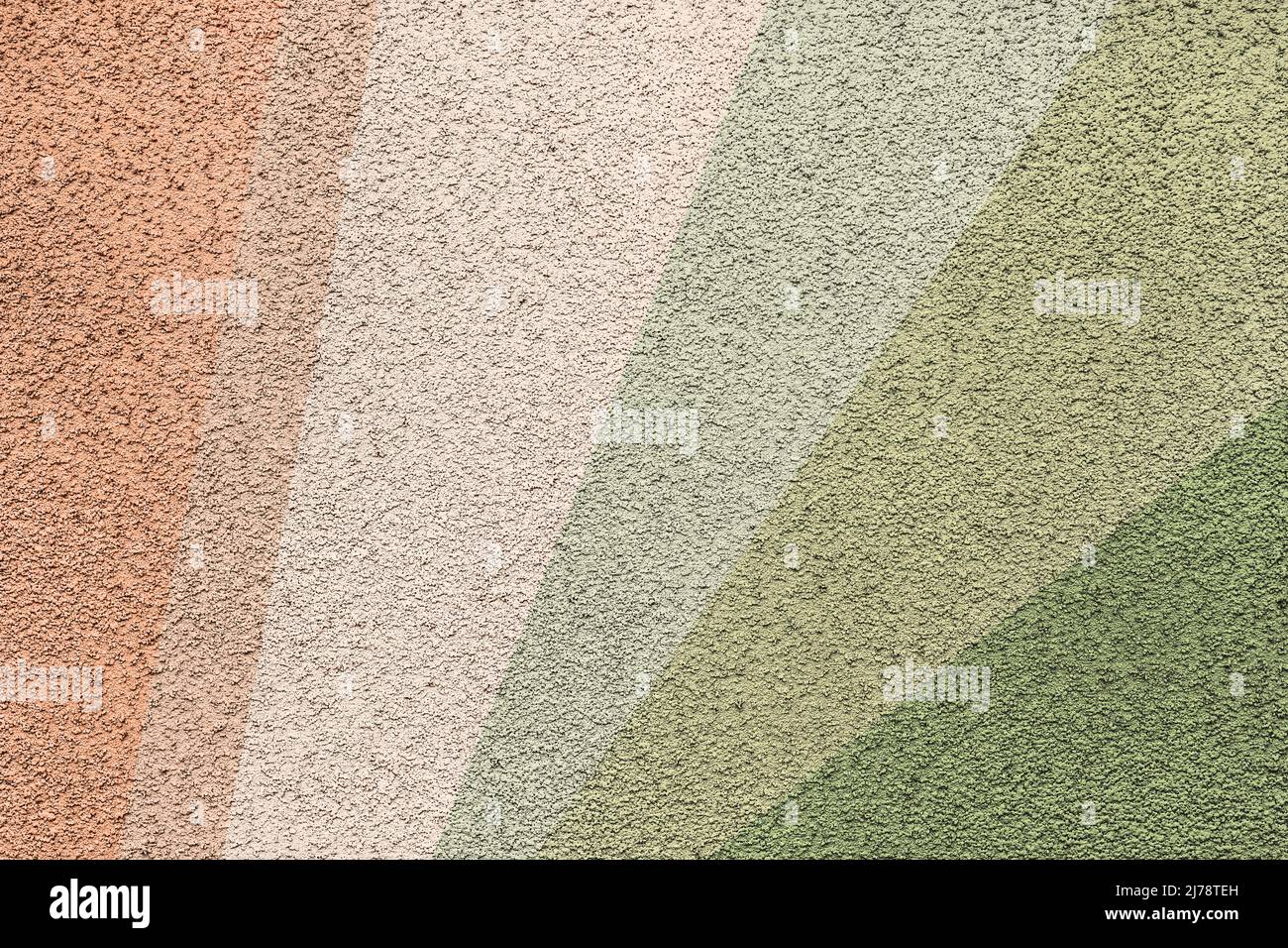 The concrete wall is painted in natural sand and green shades. Abstract ...