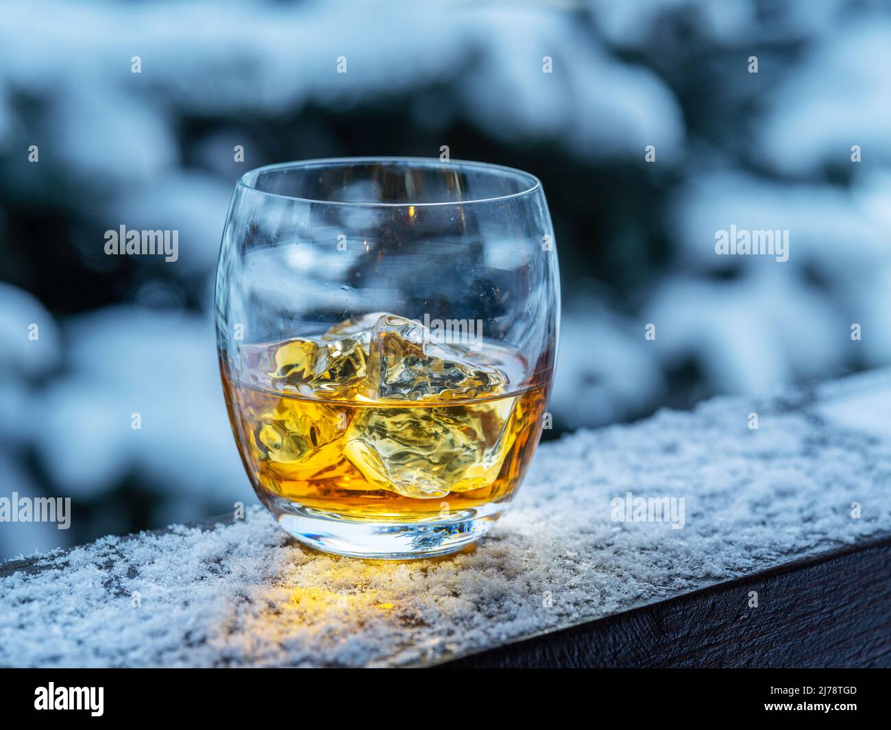 Glass of whisky on wooden board. Snowy winter background Stock Photo ...