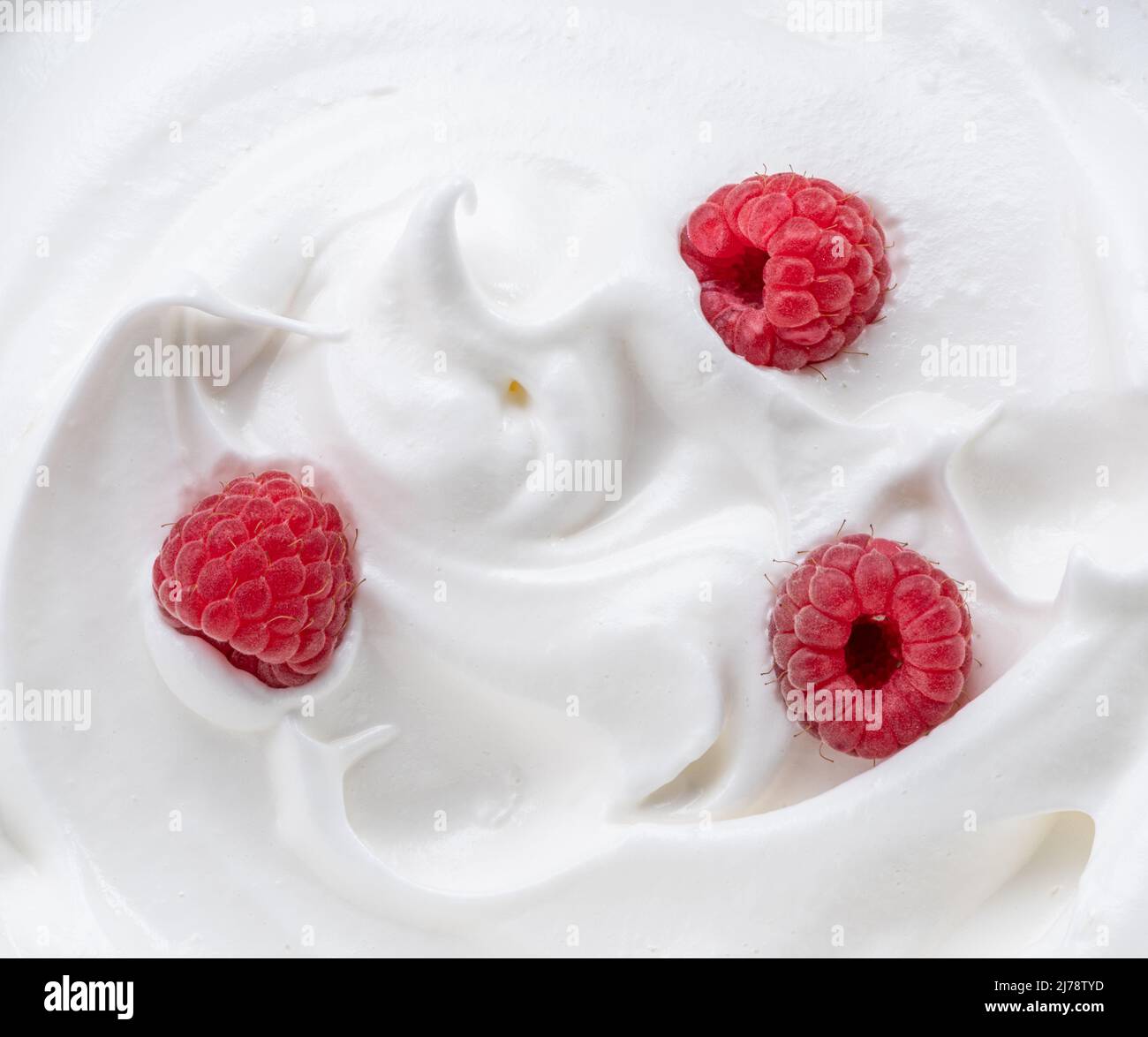 Fresh raspberries in the yoghurt or cream. Top view Stock Photo - Alamy