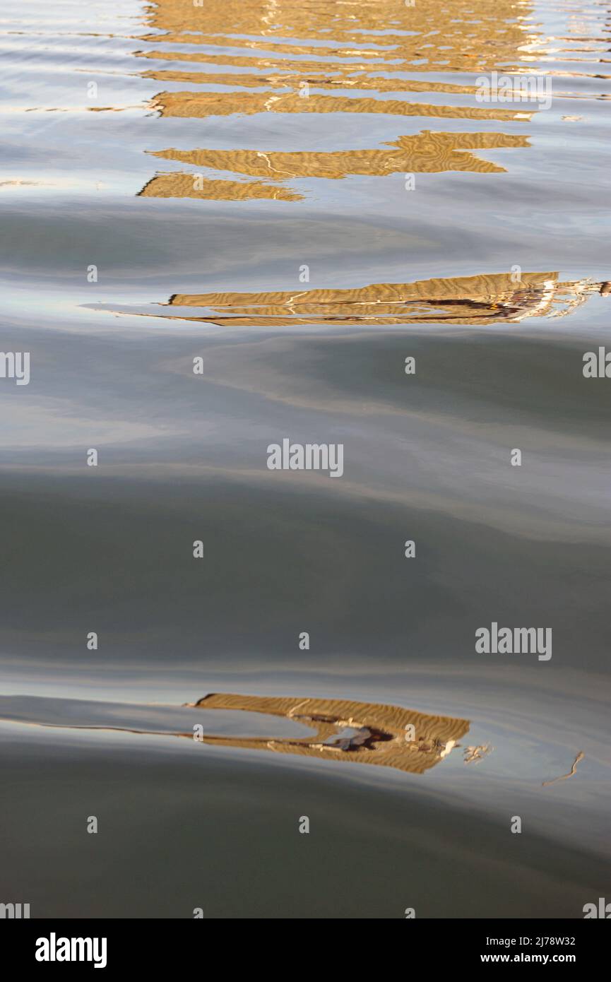 reflections and ripples in water surface of boat harbour Stock Photo ...